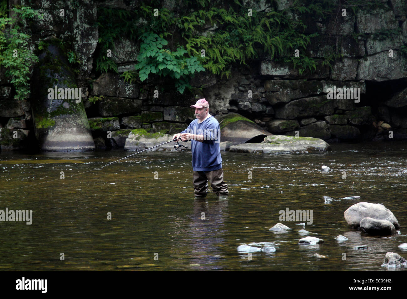 fisherman wading in a river Stock Photo - Alamy