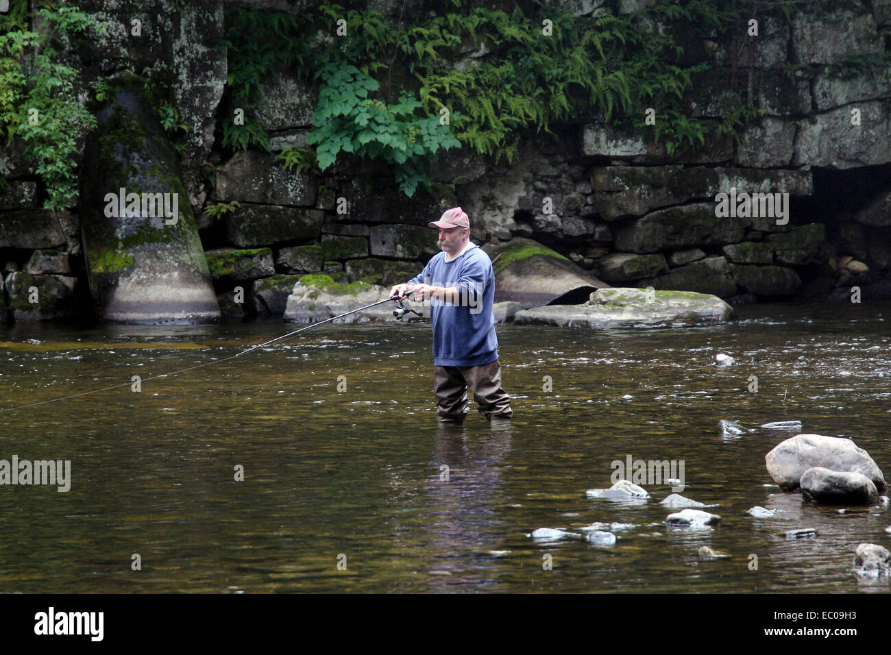 fisherman wading in a river Stock Photo - Alamy