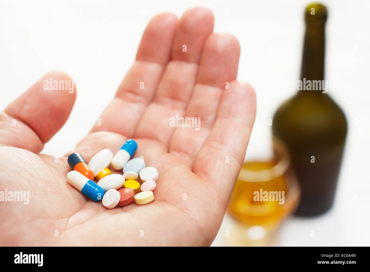 Man's hand hold many medicine. Bottle and glass with alcohol in the ...