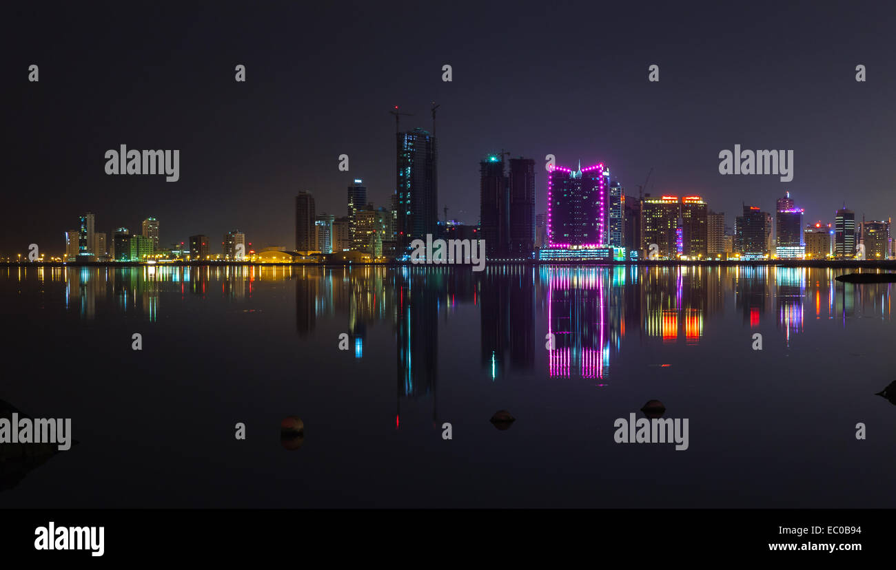 Night modern city skyline panorama with shining neon lights and ...