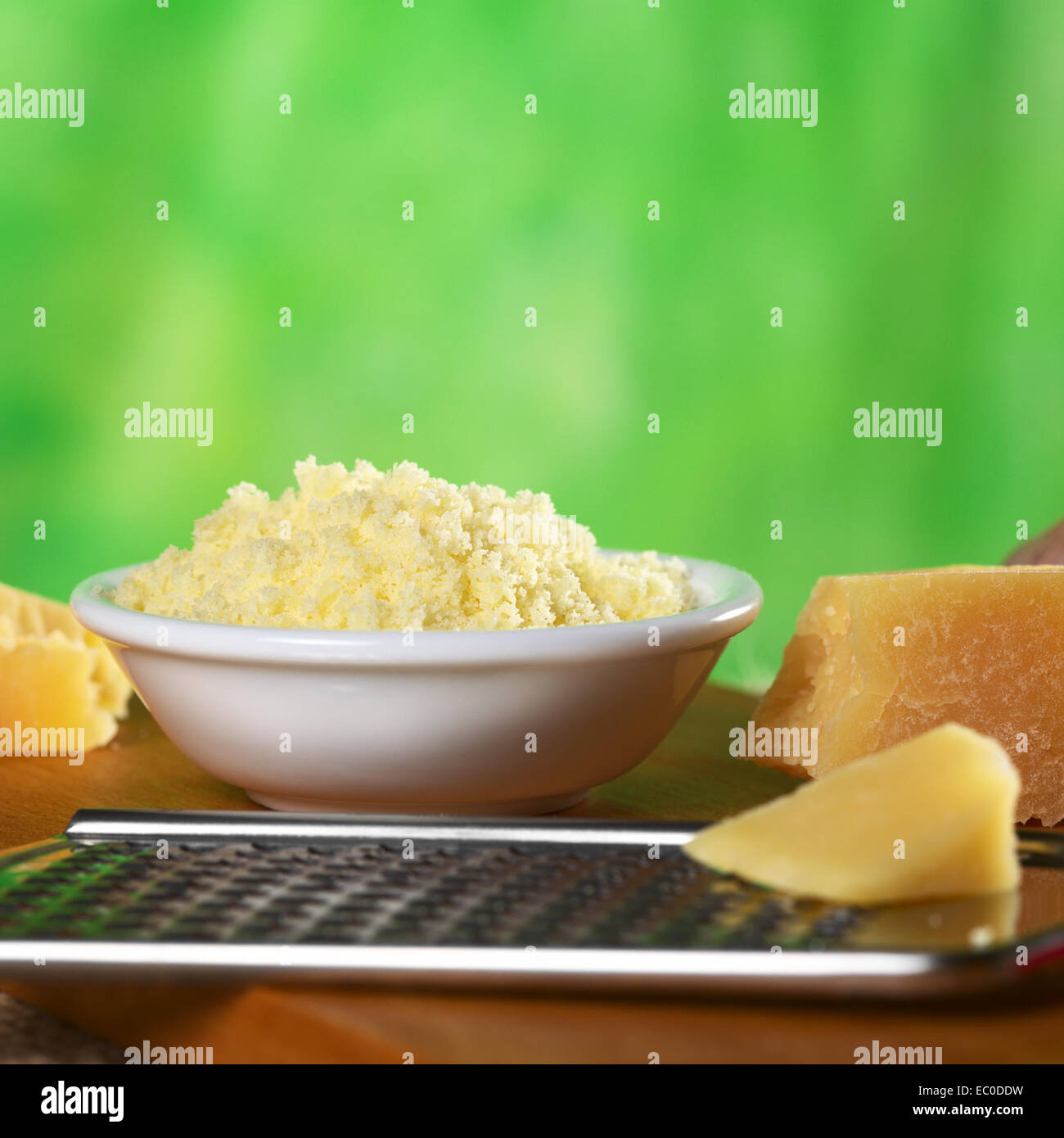 Grated Italian hard cheese with rasp in front (Selective Focus, Focus ...