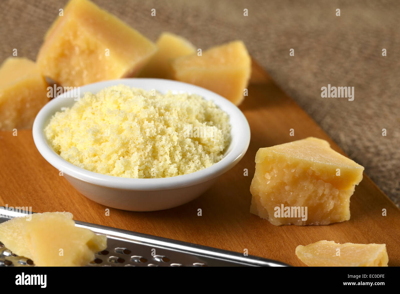 Grated Italian hard cheese with hard cheese pieces around (Selective ...