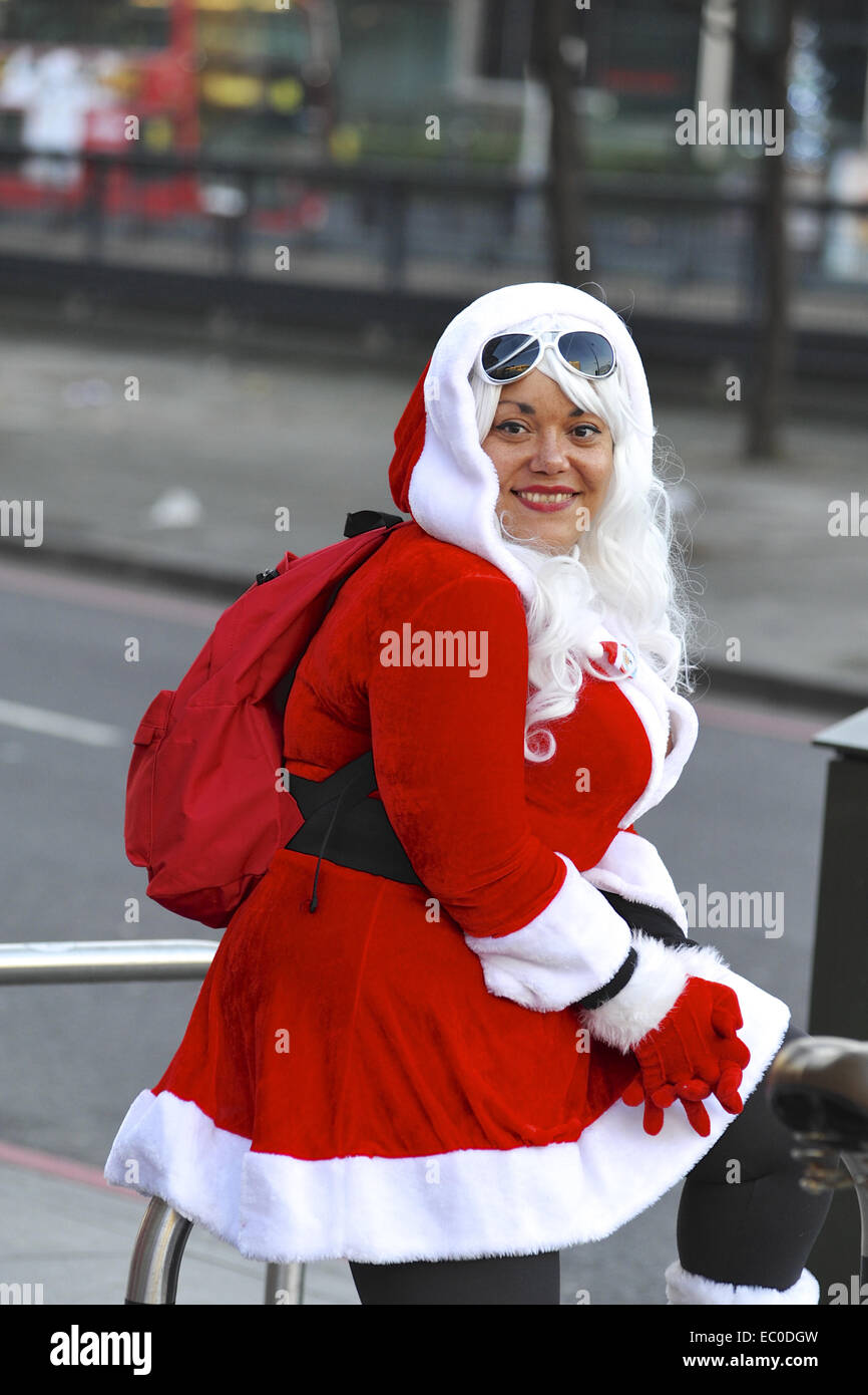 London, UK. 6th Dec, 2014. A young woman dressed as Santa Clause at the ...