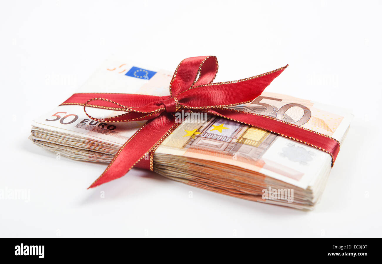 a bundle of euro bills wrapped with a red ribbon. white background ...