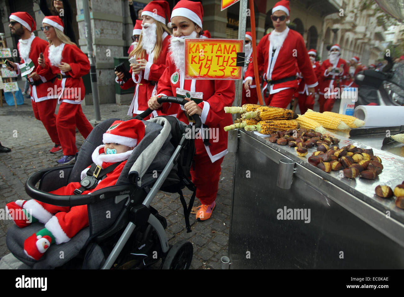 Athens, Greece. 7th Dec, 2014. Runners wearing Santa Claus suits attend ...