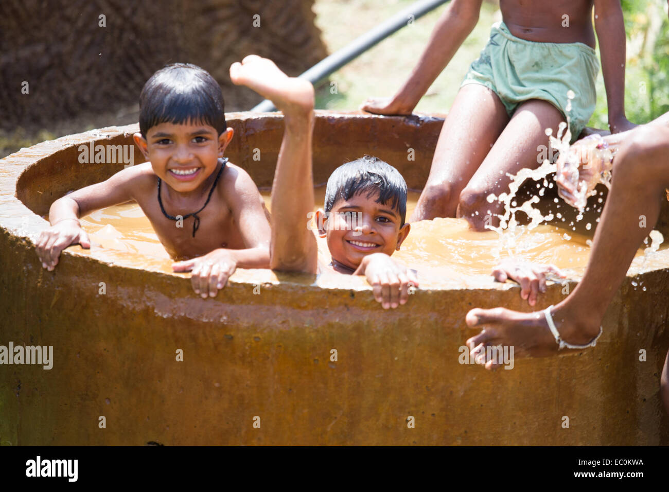 Children playing in a trough of water in Rajasthan, India Stock Photo ...