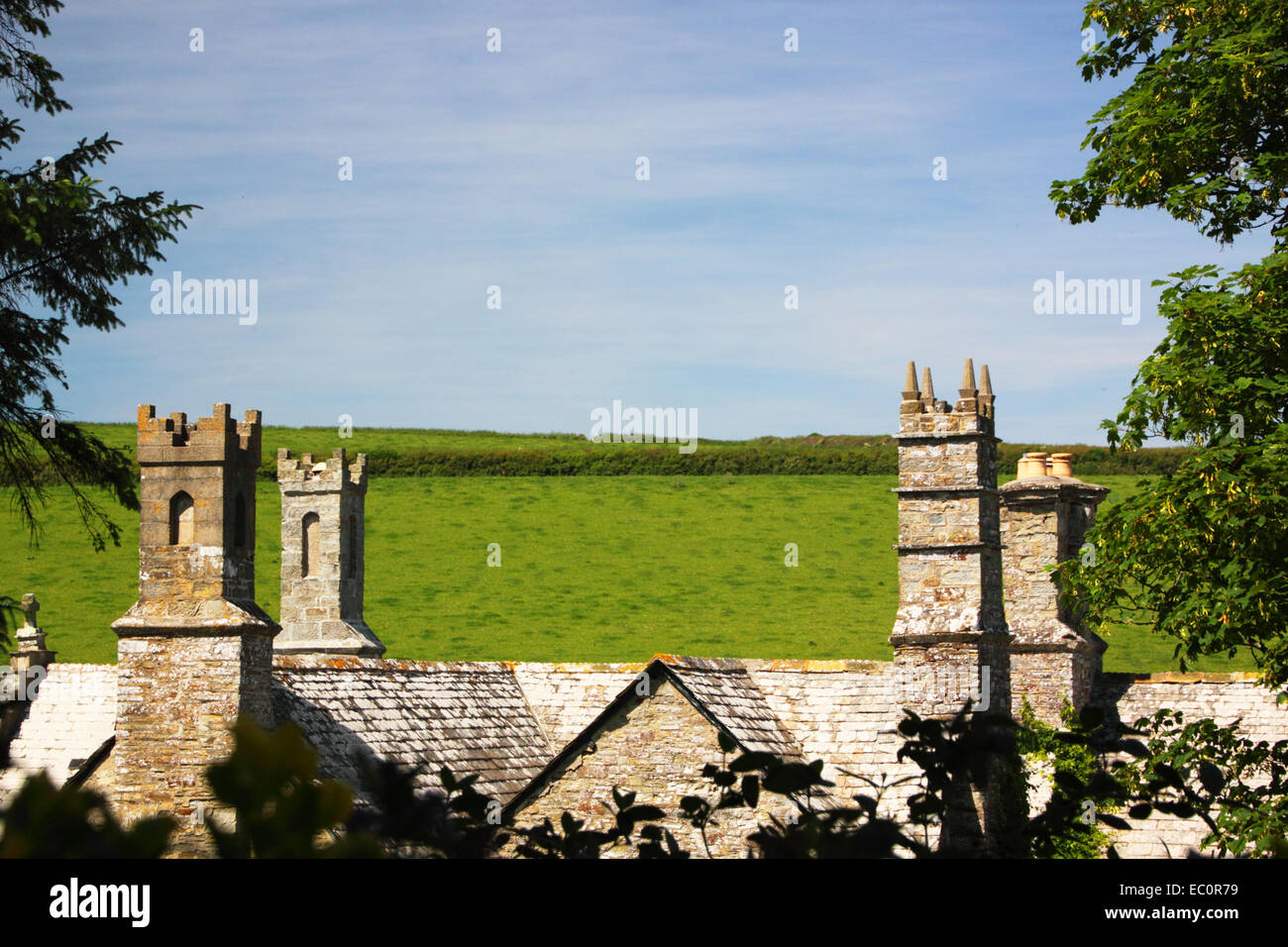 A slate roofed vicarage with chimneys which look like church towers ...