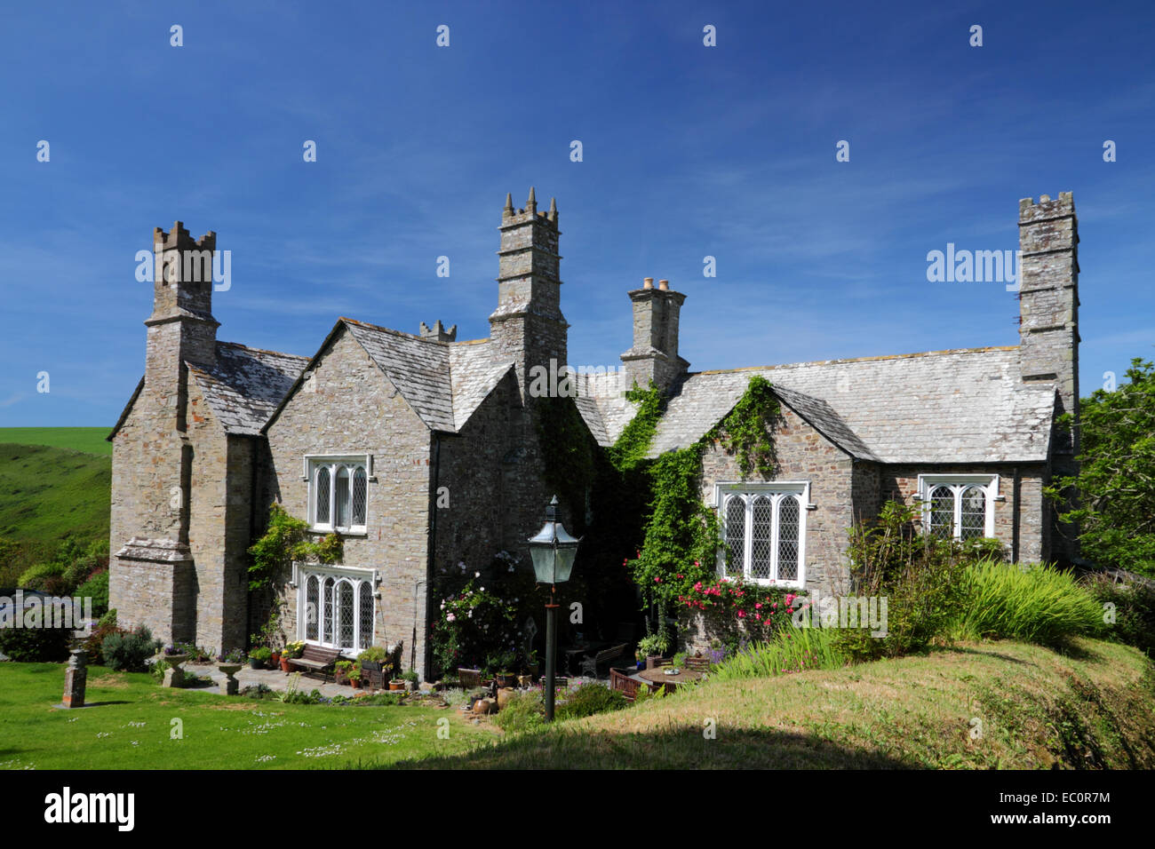 A slate roofed vicarage with chimneys which look like church towers ...