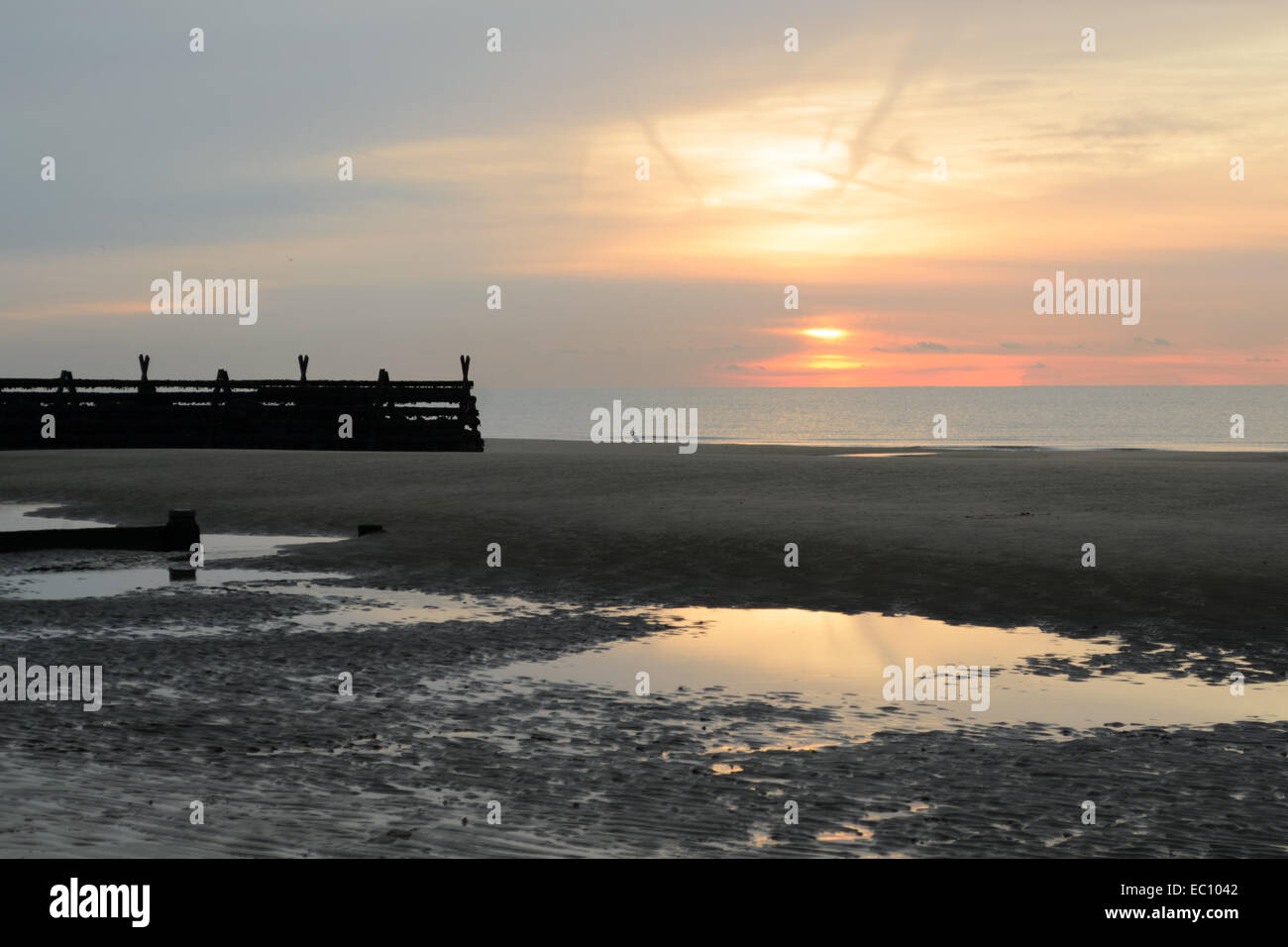 Early Morning sunrise on the beach at low tide depicting a wonderful ...