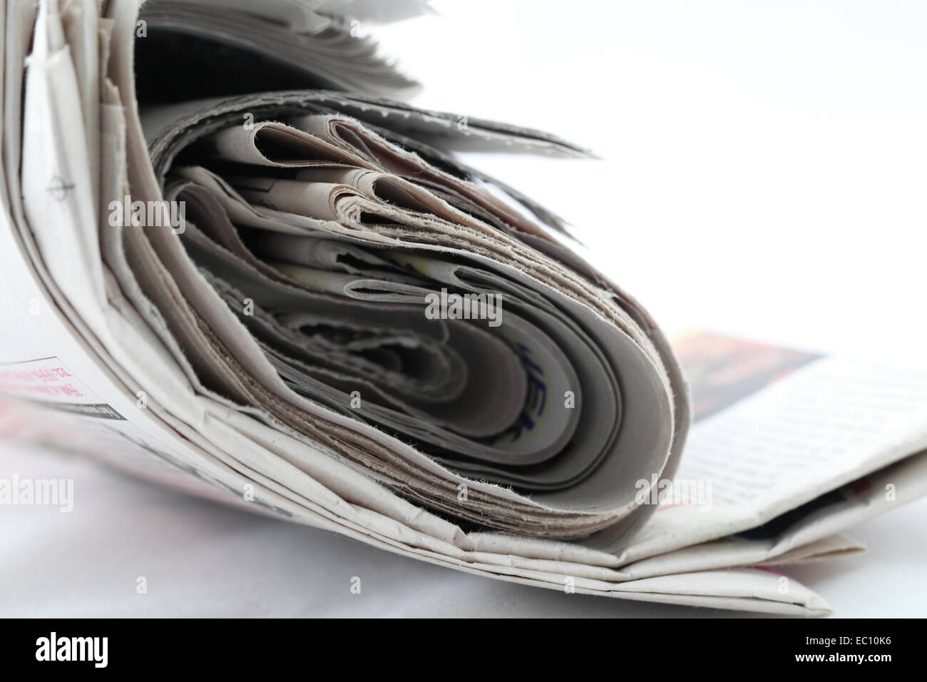 newspaper roll isolated on white background Stock Photo - Alamy