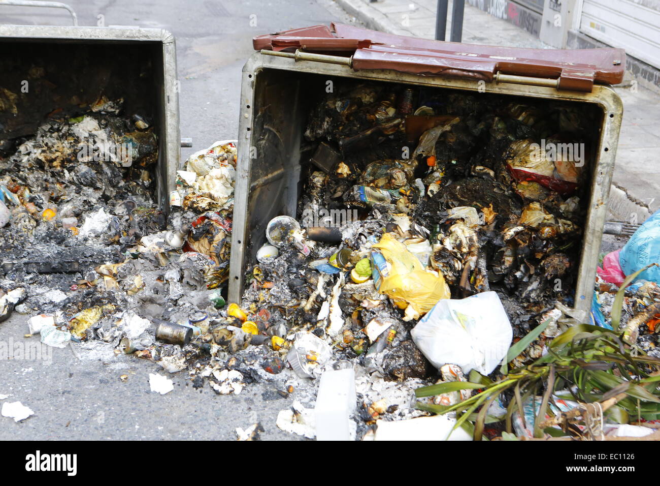 Exarchi, Greece. 7th Dec, 2014. Burnt out trash bins have been used as ...