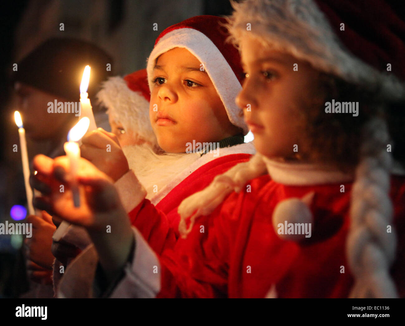 Ramallah, West Bank. 7th Dec, 2014. Palestinian girls hold candles ...