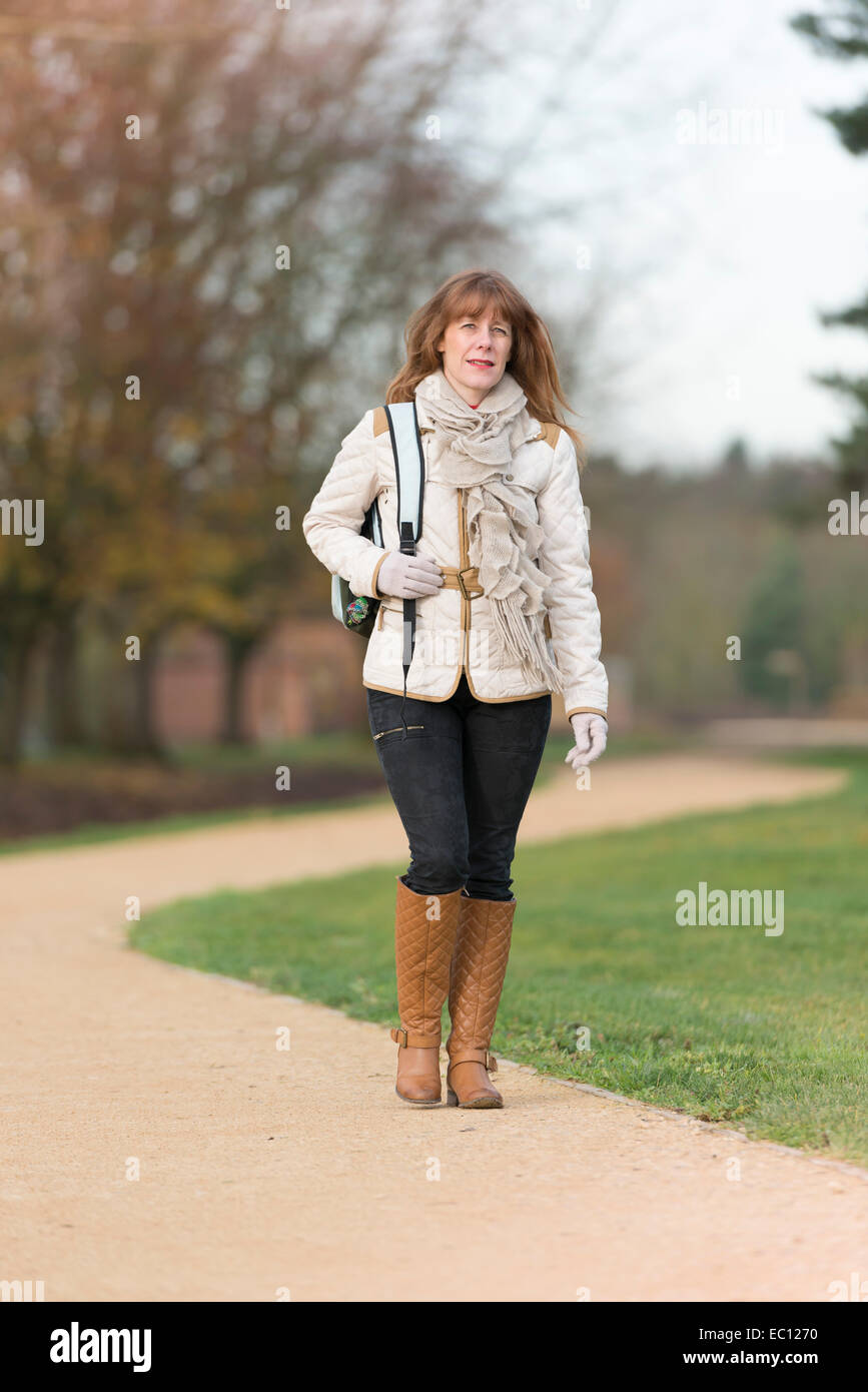 A woman walking along a country path Stock Photo - Alamy