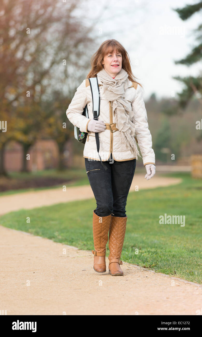 A woman walking along a country path Stock Photo - Alamy