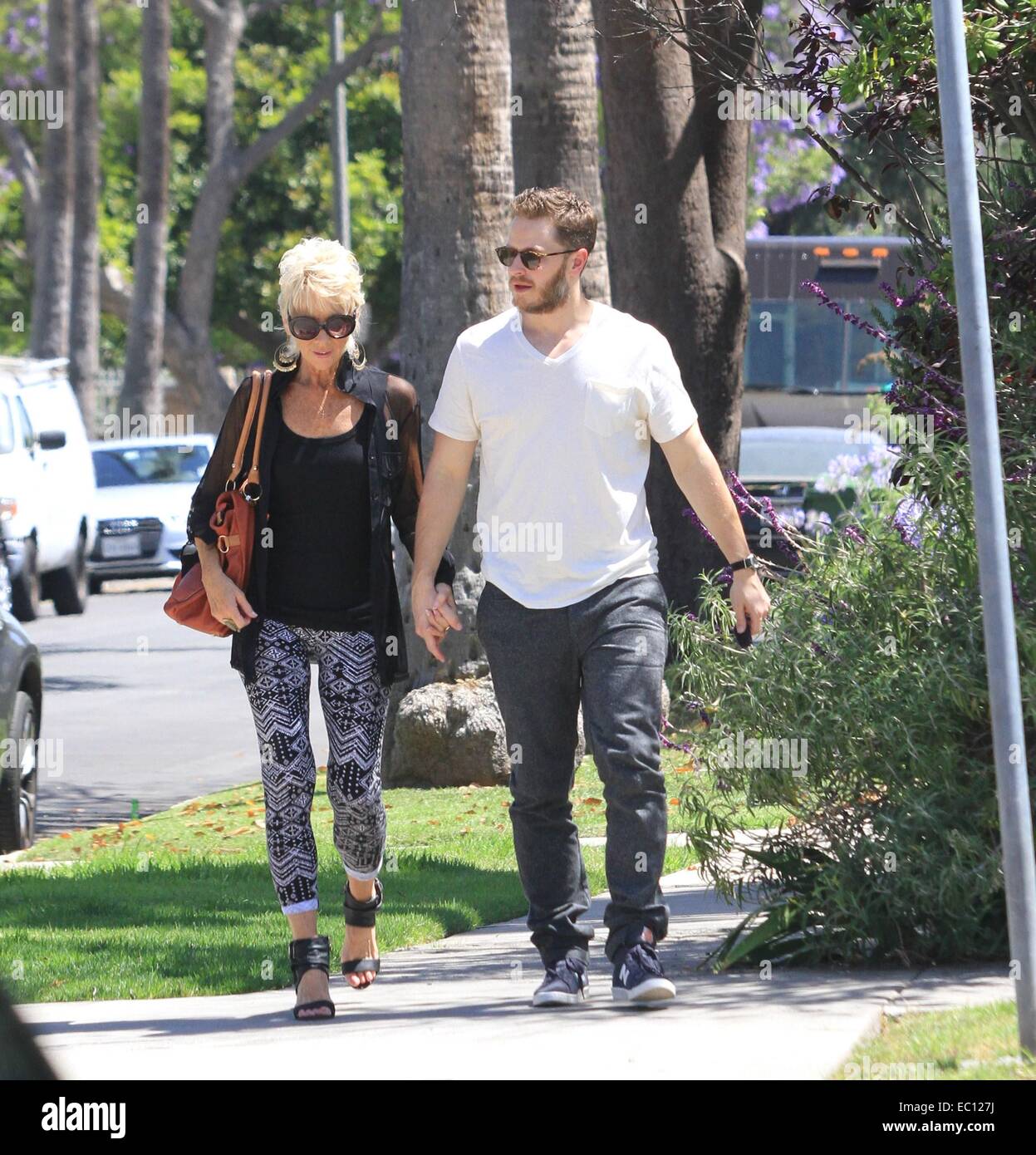Josh Dallas holds hands with an elderly female companion while out and ...