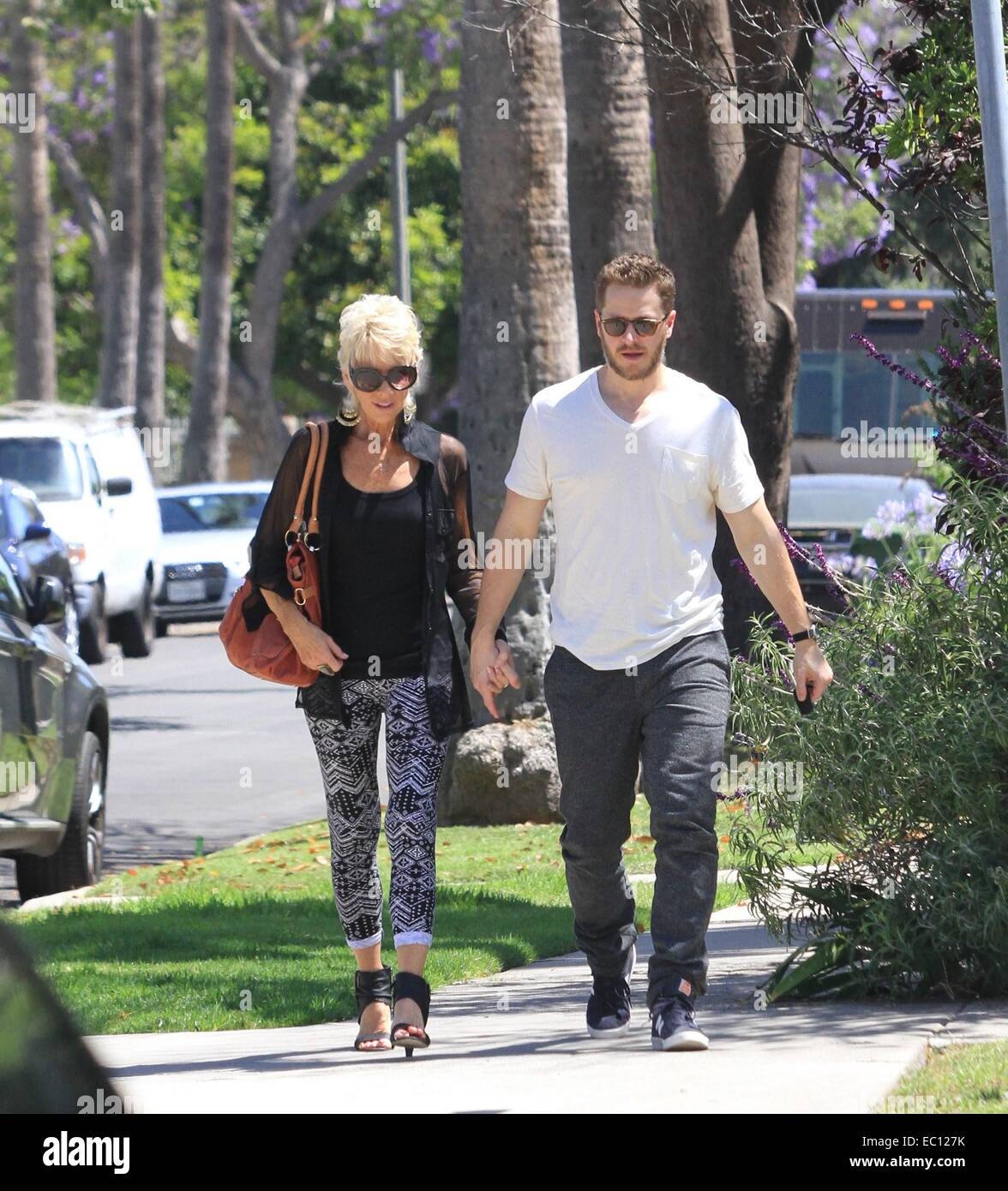 Josh Dallas holds hands with an elderly female companion while out and ...