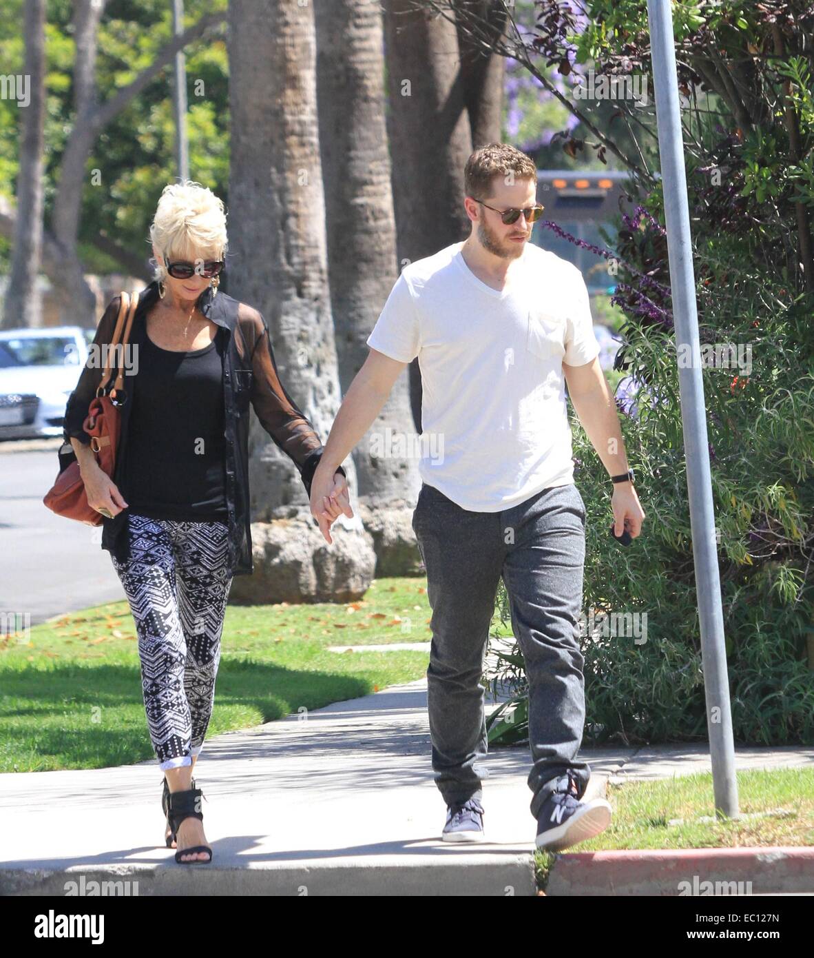 Josh Dallas holds hands with an elderly female companion while out and ...