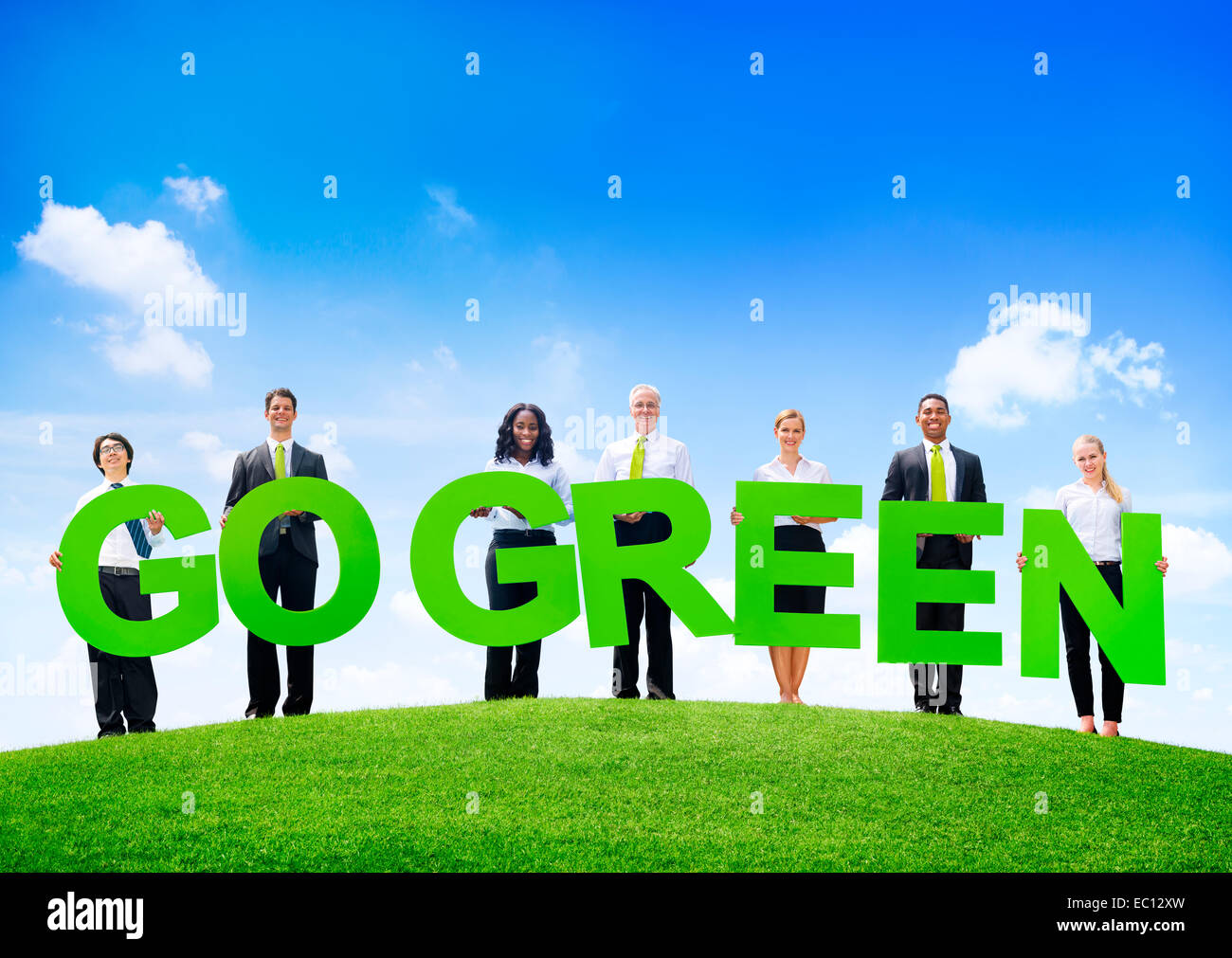 Business People Outdoors Holding Texts Go Green Stock Photo - Alamy