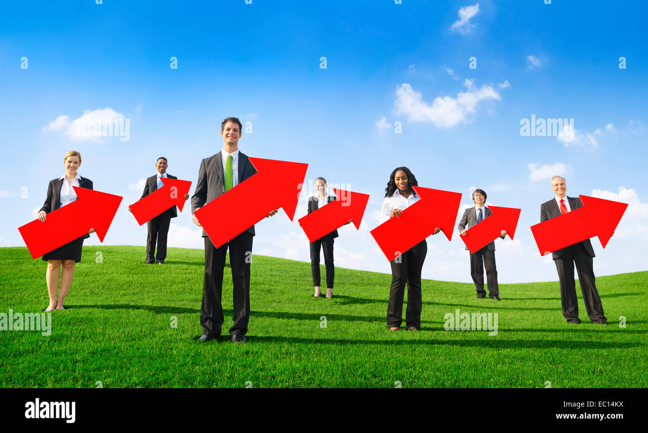 Cheerful Business People Holding Arrows Pointing Above Stock Photo - Alamy