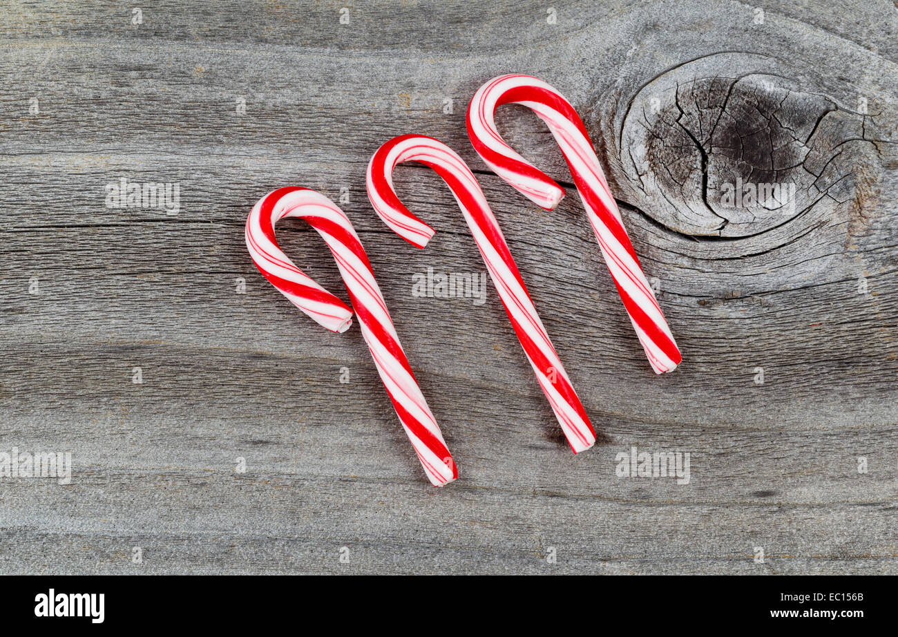 Top view close up of three candy canes placed on rustic wood Stock ...