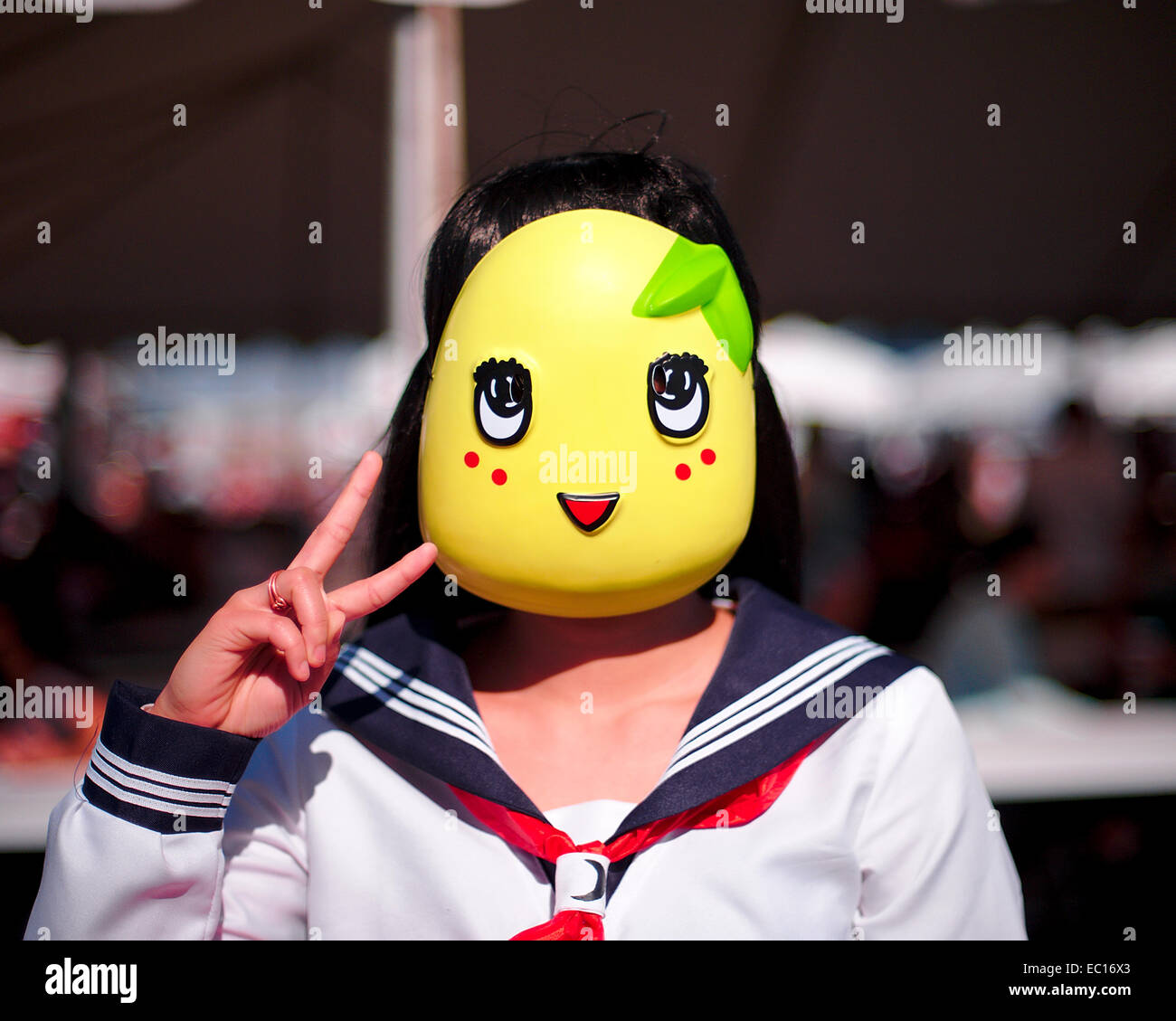 A young girl wearing a Funassyi mask showing the peace sign at the Las ...