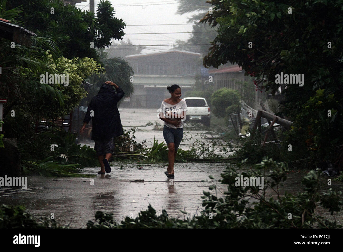 Cebu, Philippines. 7th Dec, 2014. Residents run to safe places to evade ...