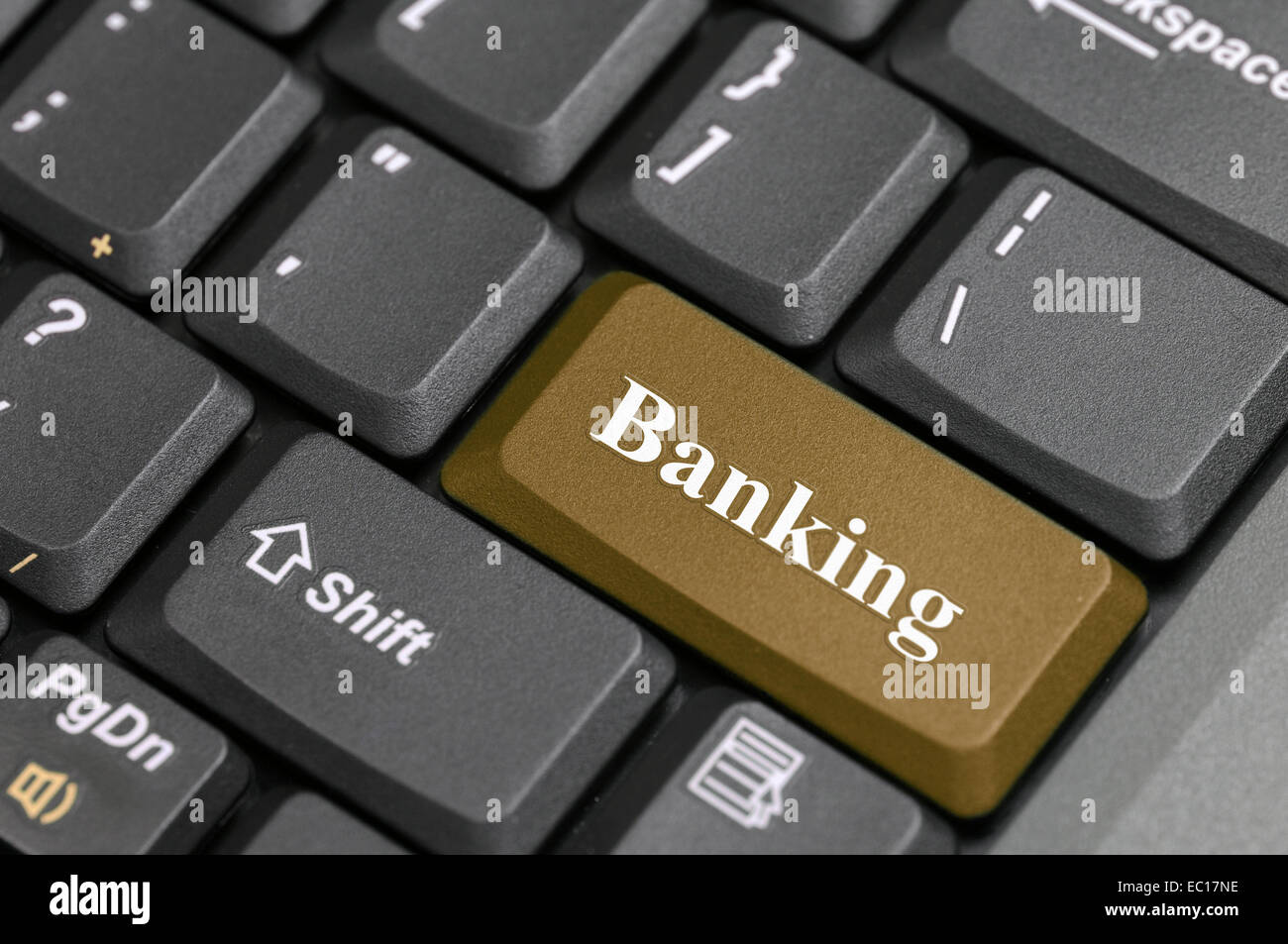 Brown banking key on keyboard Stock Photo - Alamy
