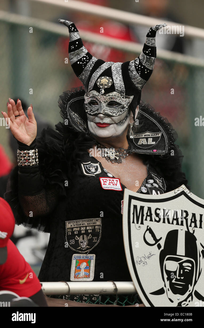 Oakland, CA. 07th Dec, 2014. A Raiders fan shows off her attire during ...