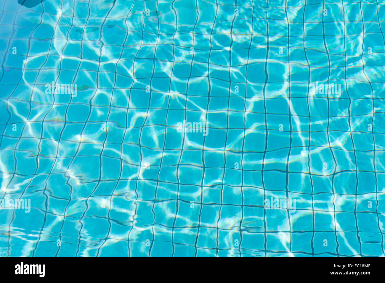 Blue pool water with sun reflections Stock Photo - Alamy