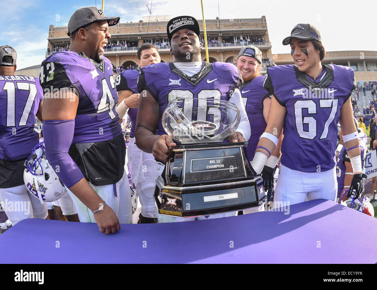 TCU players celebrate and pose with the Big-12 trophy after an NCAA ...