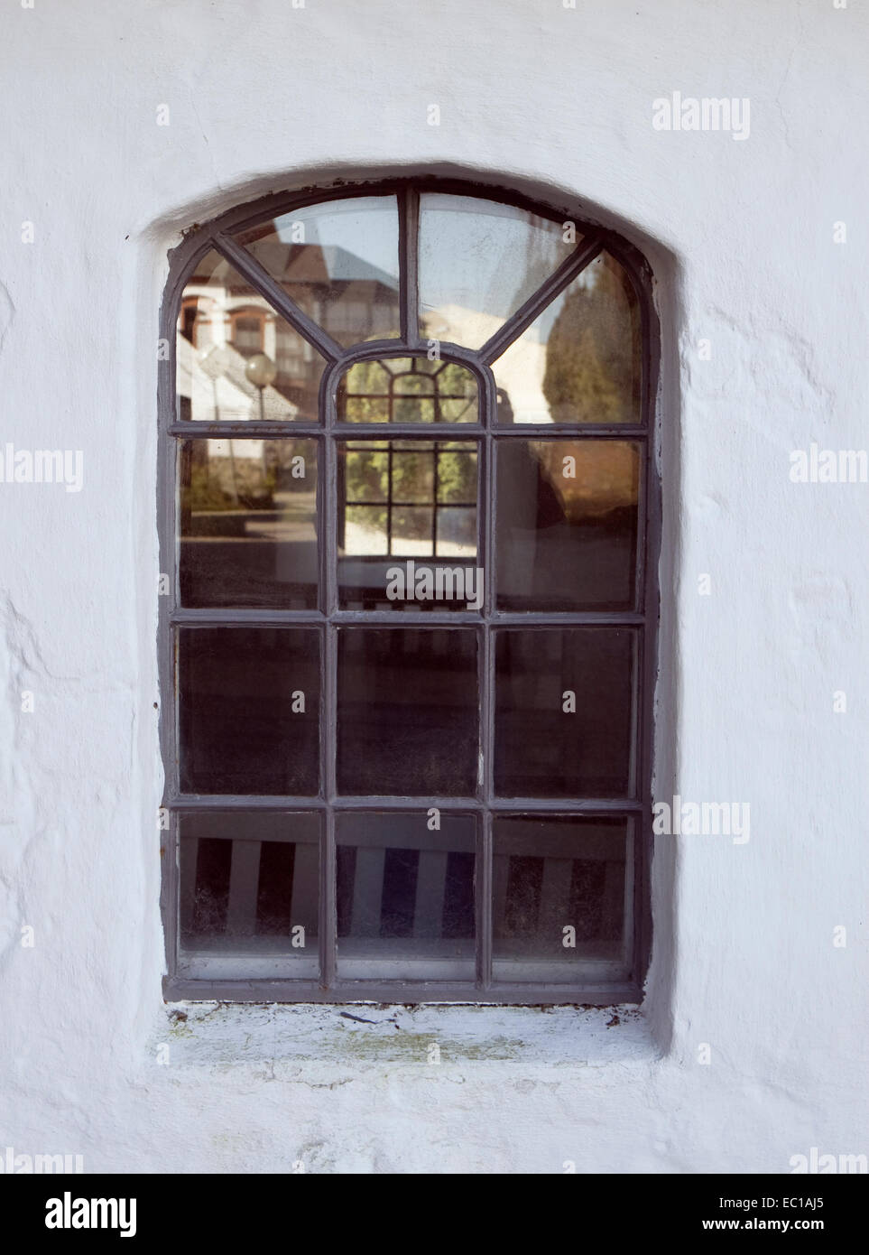 Reflections of a building in a small church window Stock Photo - Alamy