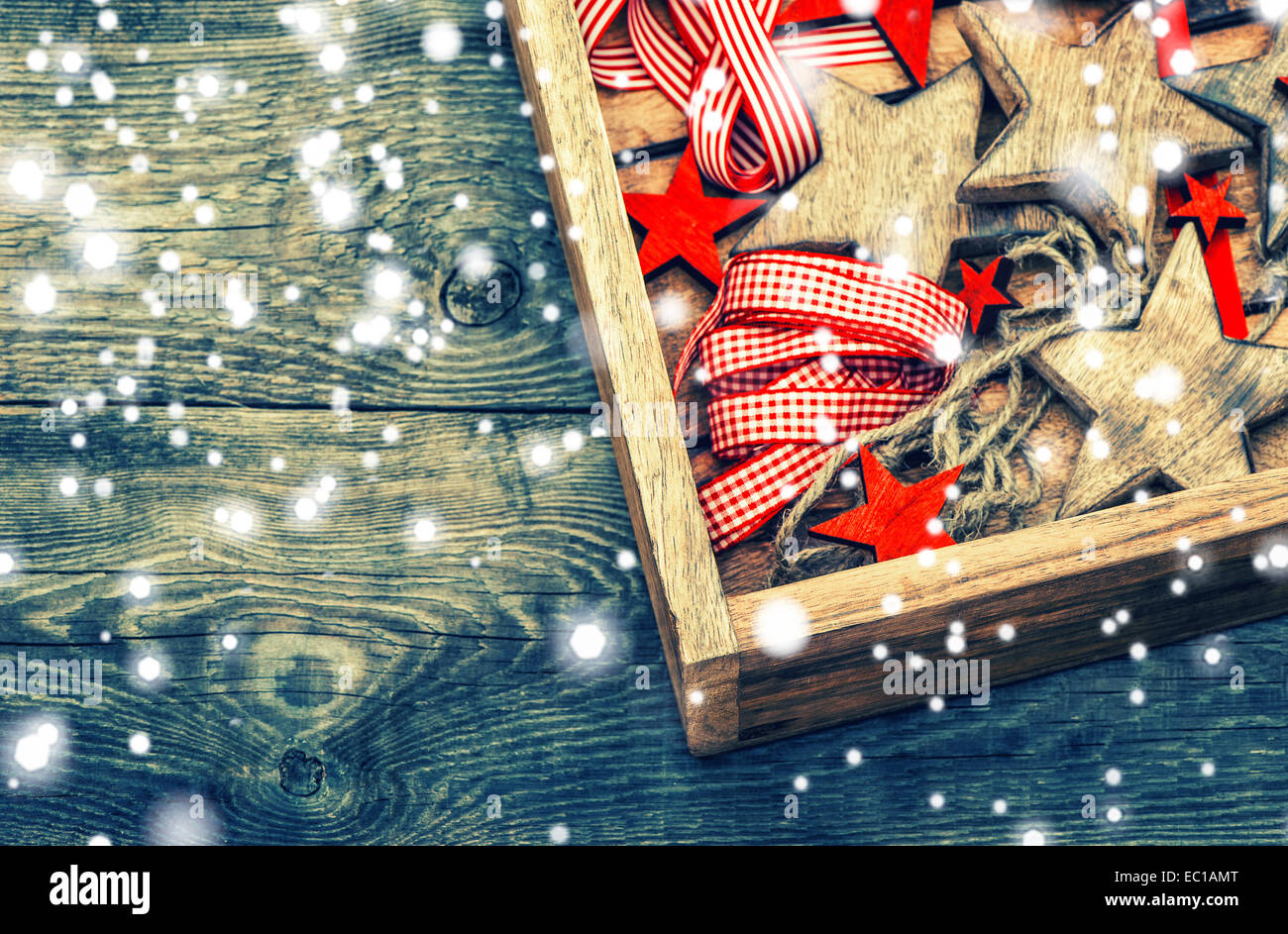 christmas decorations wooden stars and red ribbons on rustic wooden background. vintage style ...
