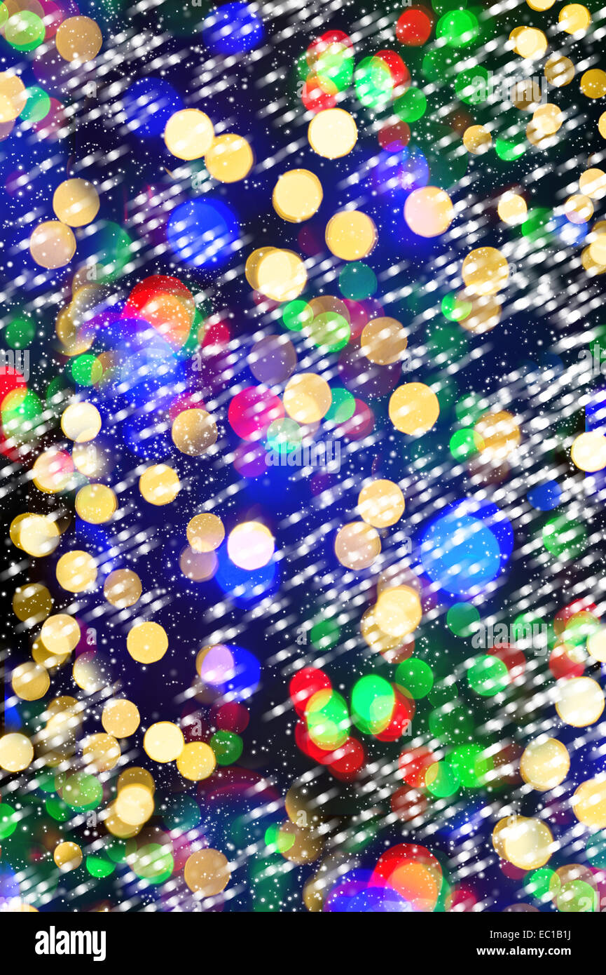 defocused city lights with snowfall effect. abstract shiny multicolor ...