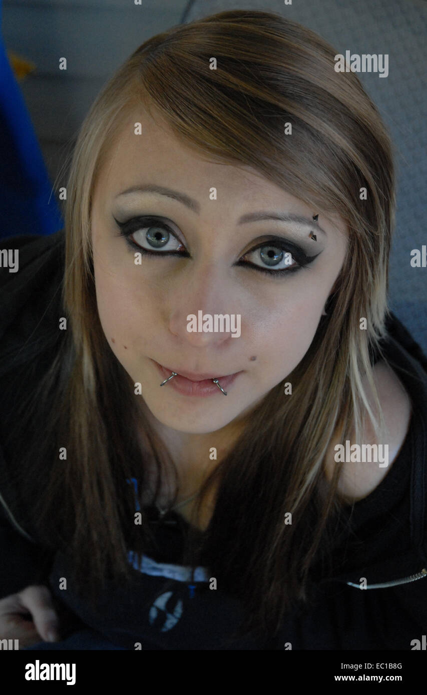 Attractive Young Woman With Distinctive Eye Makeup And Facial Piercings