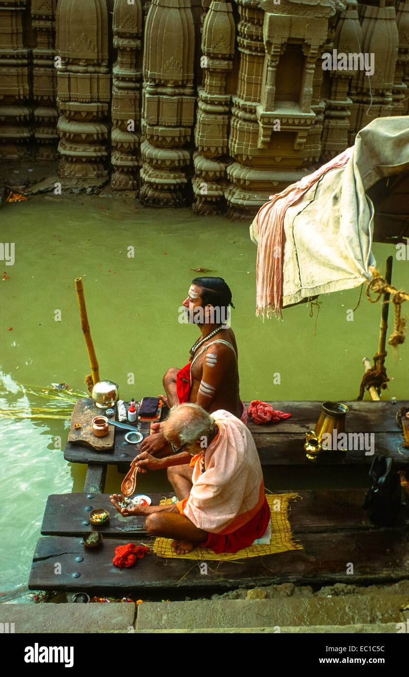 two men praying at the ganga river in varanasi in india Stock Photo - Alamy