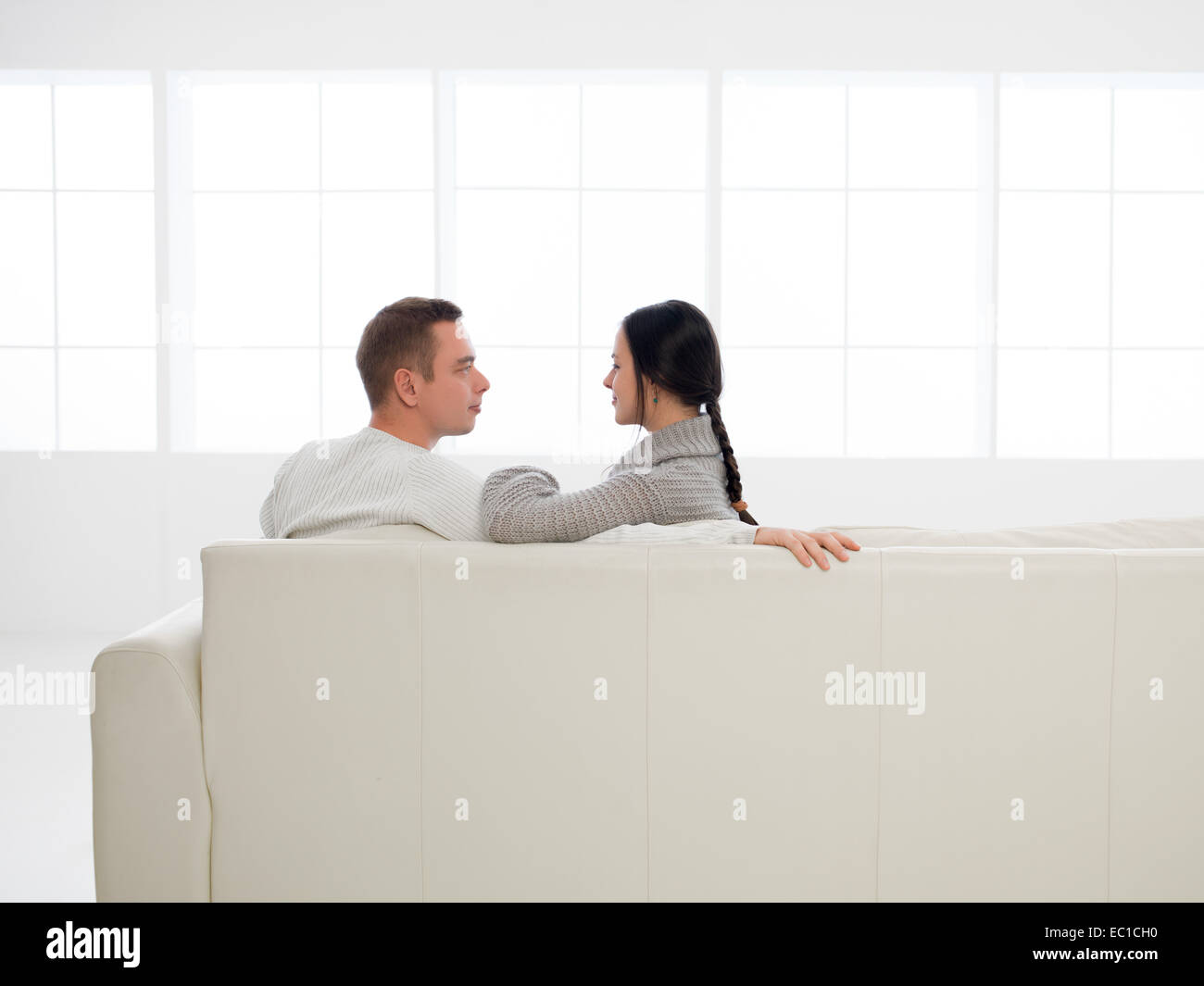 Loving Young Couple Sitting On The Couch At Home Stock Photos & Loving ...
