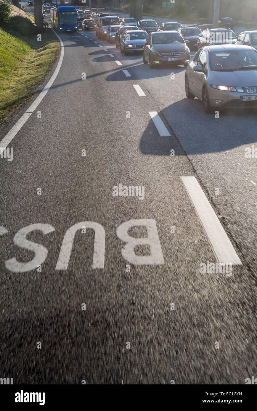 Cars in queue by empty bus lane Stock Photo - Alamy