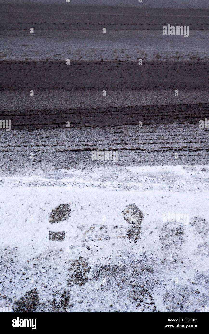 Shoe marks in snow on roadside Stock Photo - Alamy