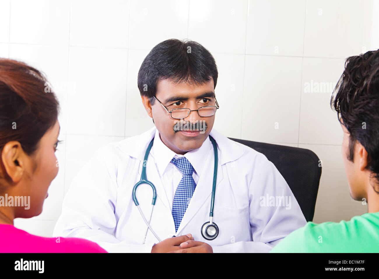 Doctor examining patients report hi-res stock photography and images ...