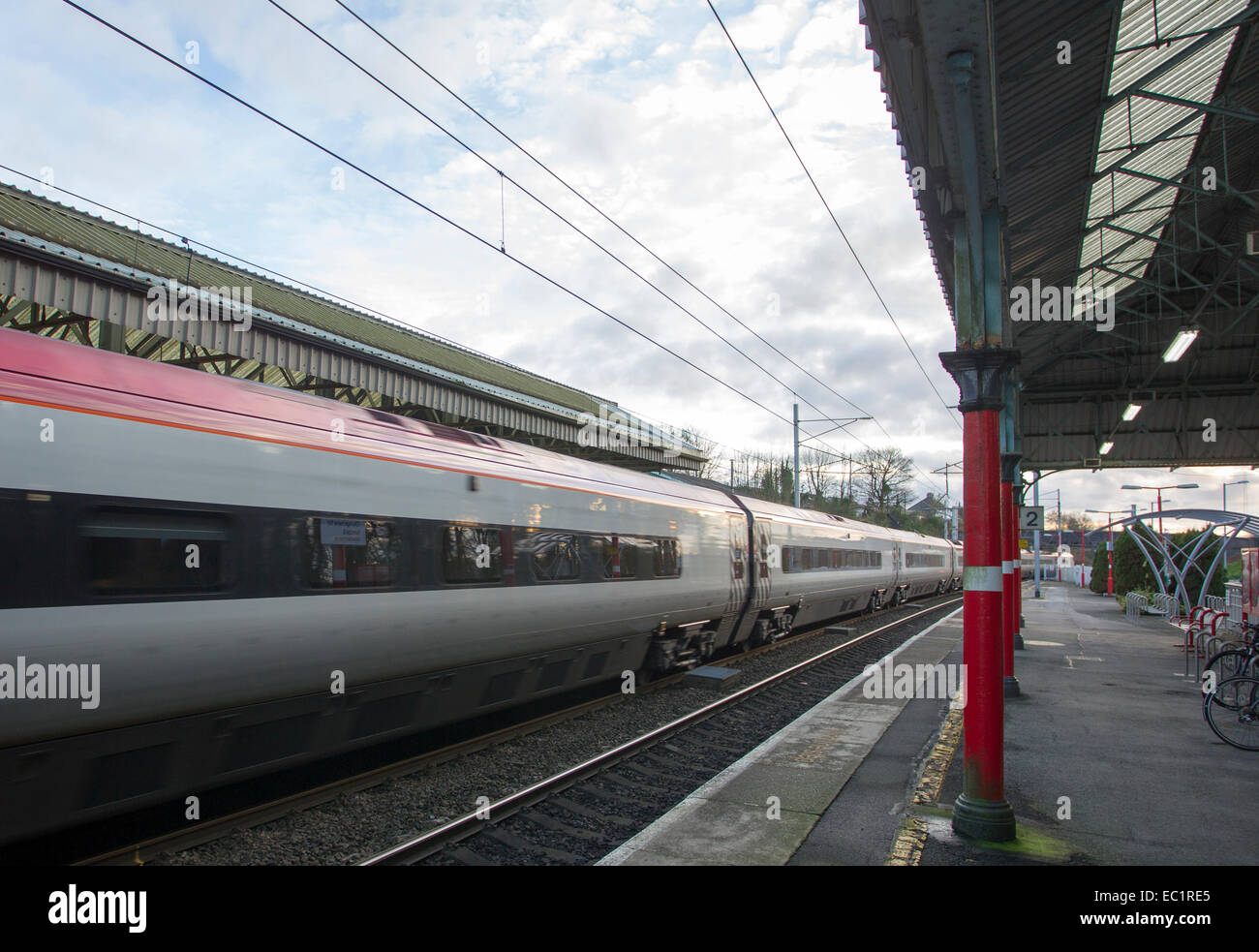 Speeding train passing through station hi-res stock photography and ...