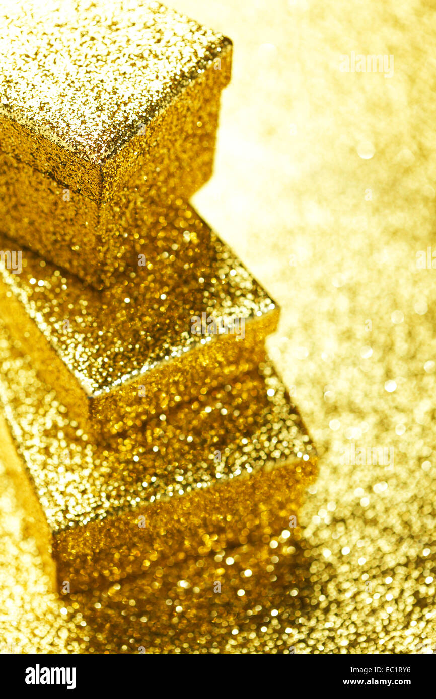 Decorative golden boxes with holiday gifts on shiny glitter background ...