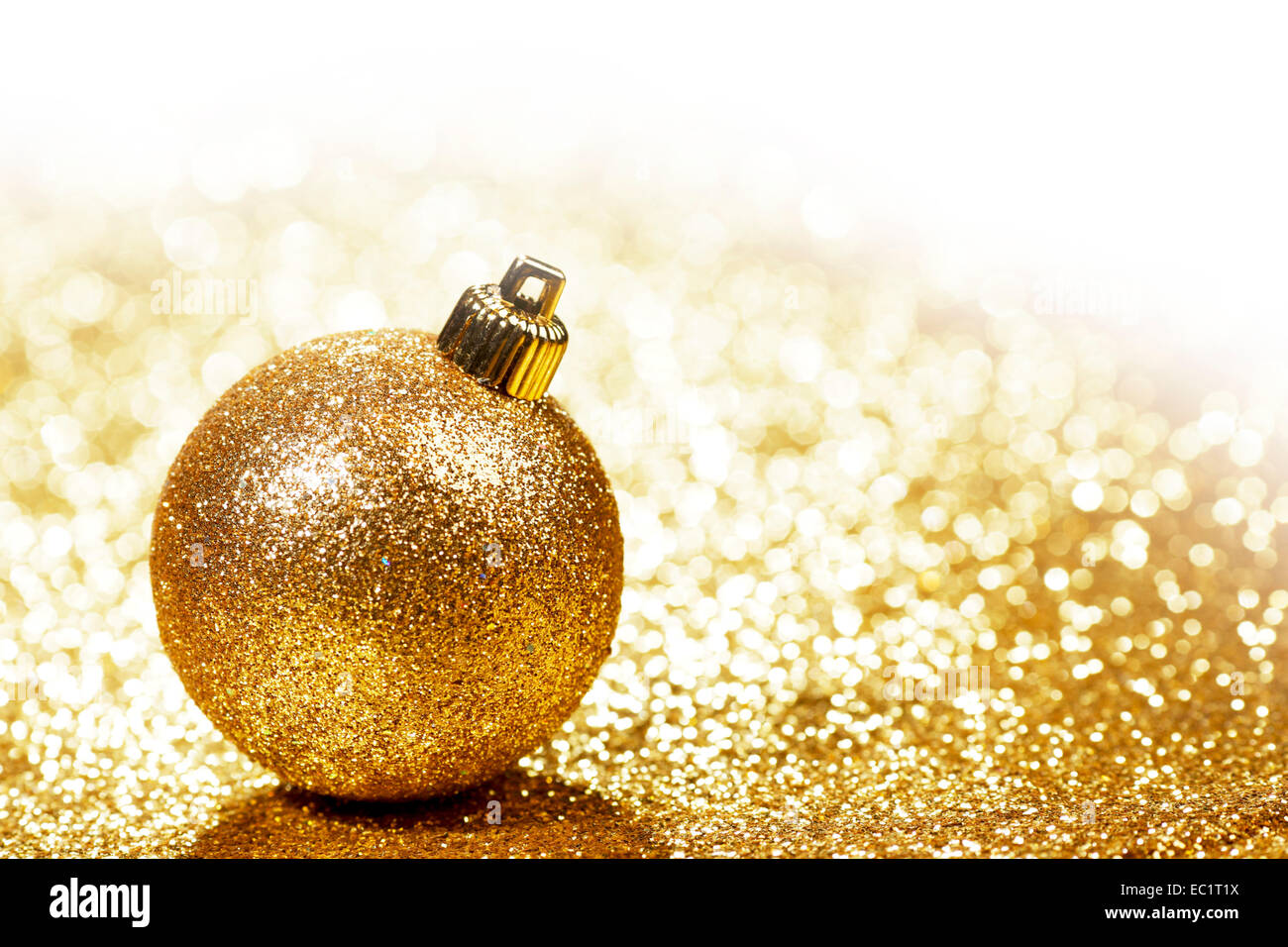 Golden christmas ball on shining glitter background close-up Stock ...