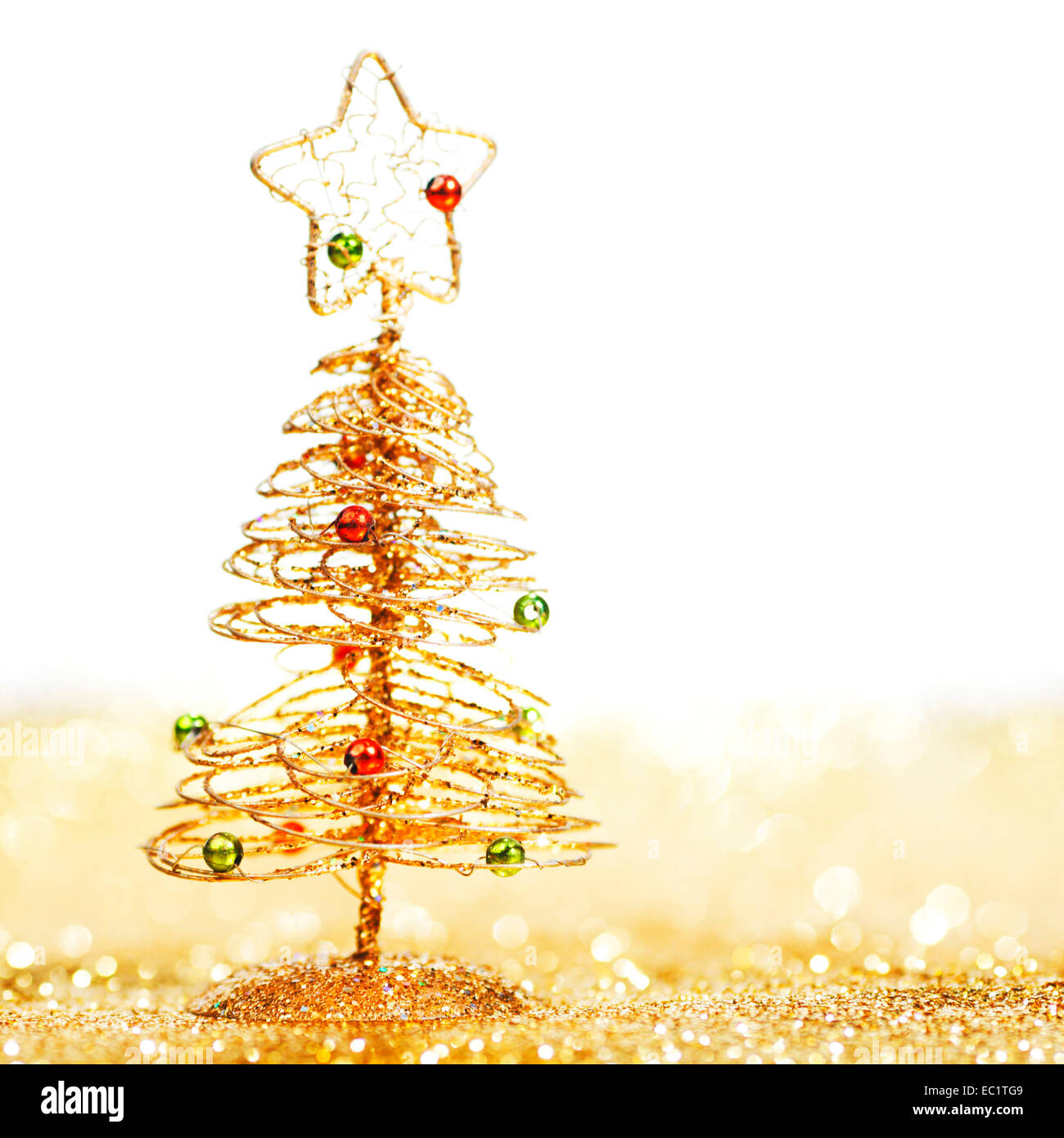 Beautiful golden decorative christmas tree on golden glitter background ...