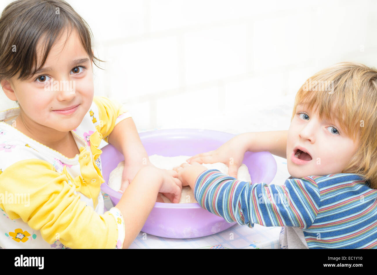 Sweet Kids playing in the kitchen Stock Photo - Alamy