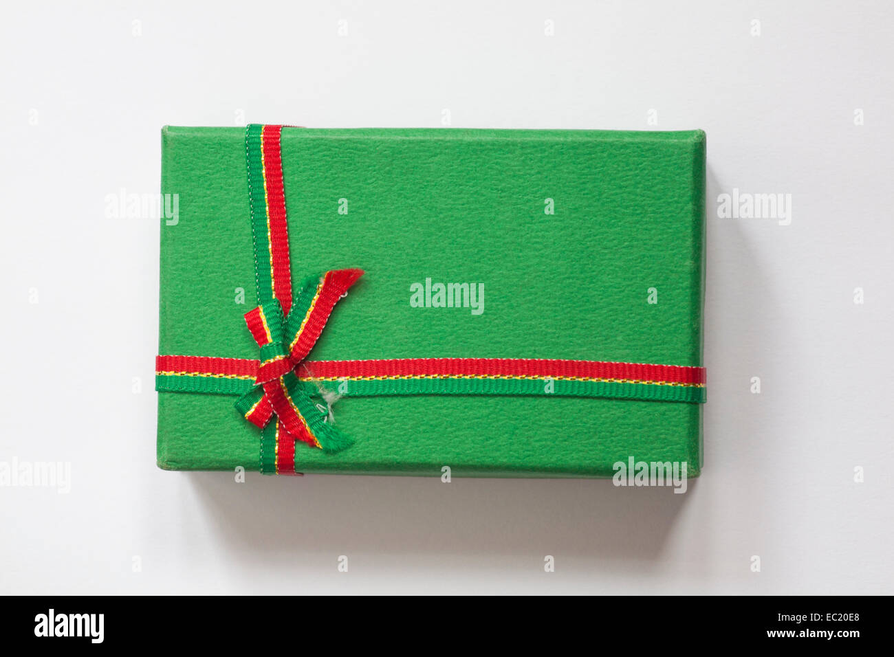 green gift box with red and green ribbon isolated on white background ...