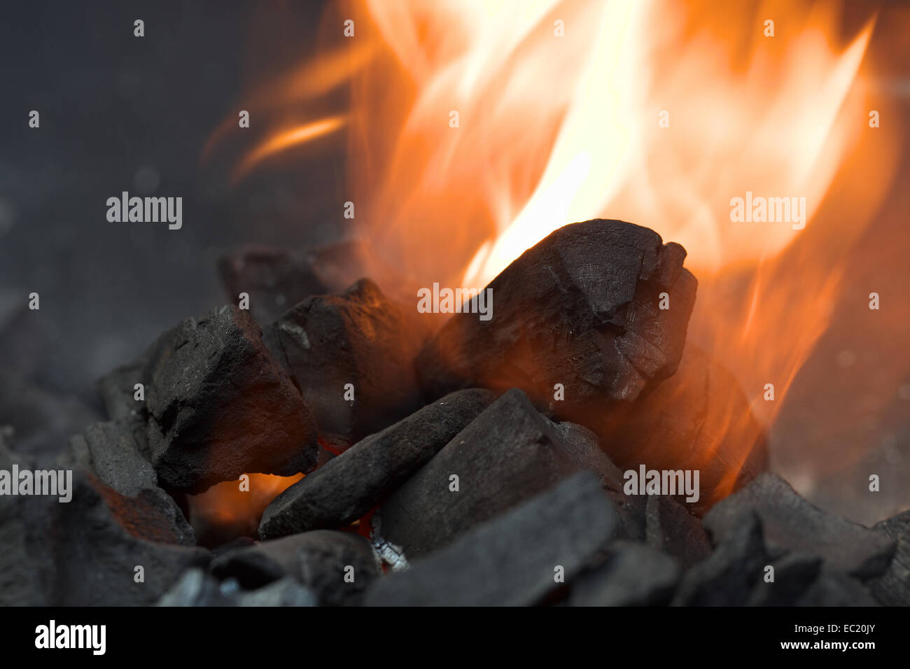 Burning charcoal with orange-colored flame and smoke Stock Photo - Alamy