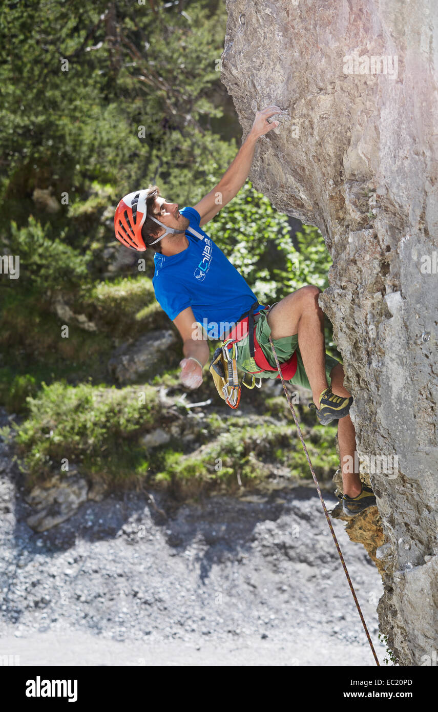 Sport climber wearing a helmet climbing a rock face, Ehnbachklamm gorge ...