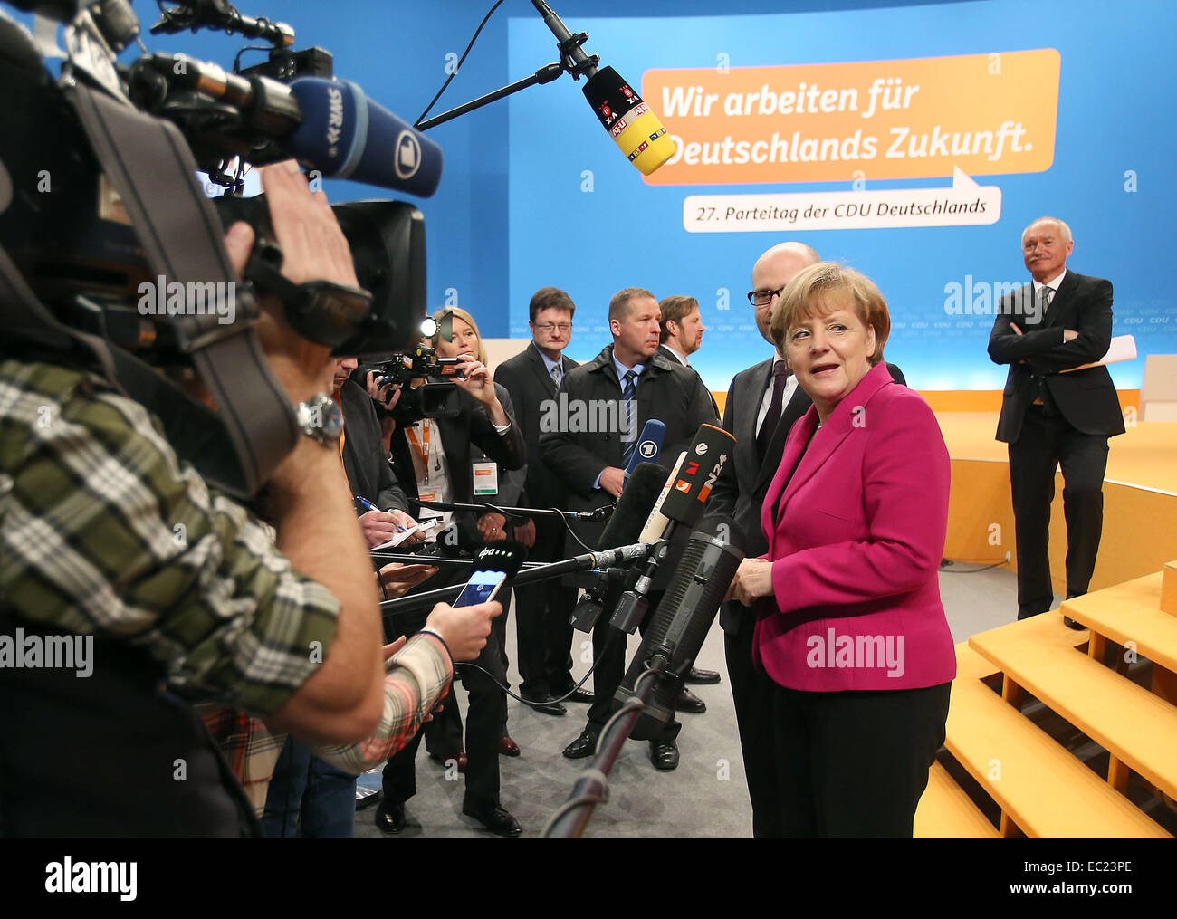 Chancellor Angela Merkel delivers a statement after inspecting the hall ...
