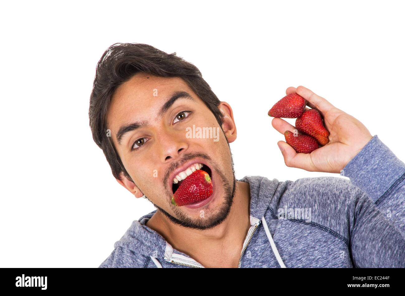 closeup portrait young man eating red strawberries Stock Photo - Alamy