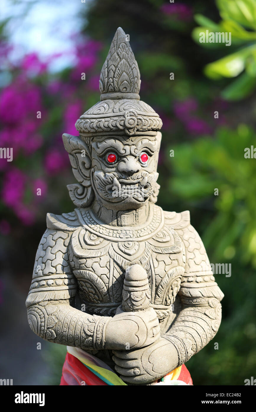 Thai statue war with red eyes photographed closeup Stock Photo - Alamy